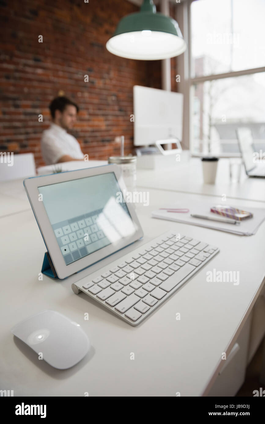 Digital tablet on desk in office Stock Photo - Alamy
