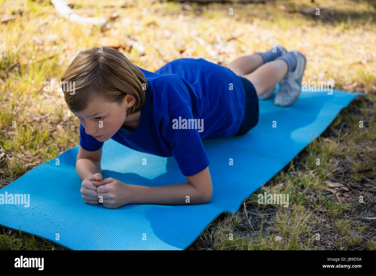 Girl exercising on exercise mat during obstacle course training in the ...