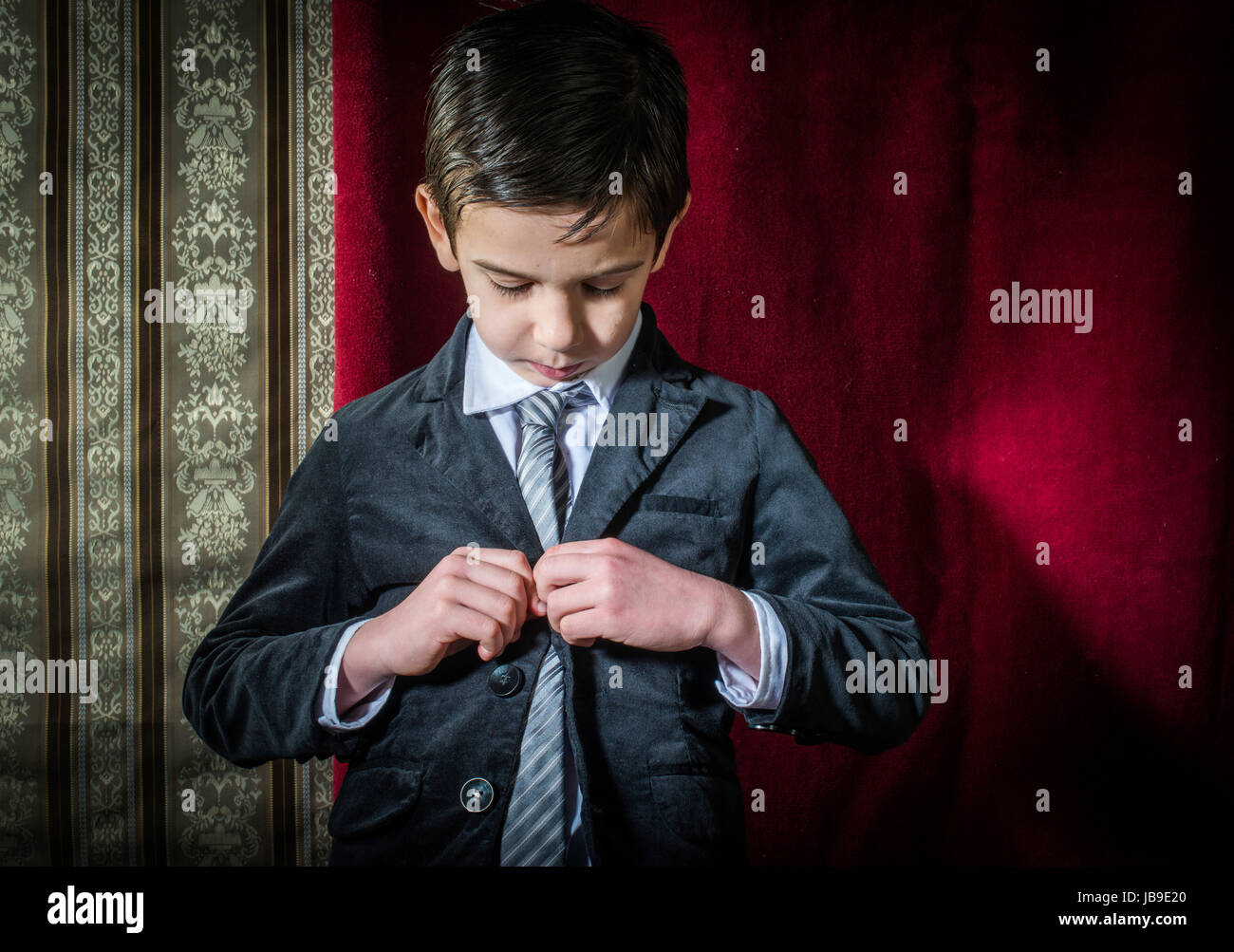 Boy in vintage black suit and tie Stock Photo - Alamy