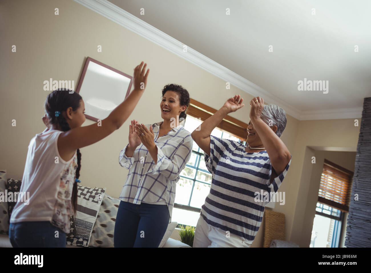 Happy family having fun in living room at home Stock Photo - Alamy