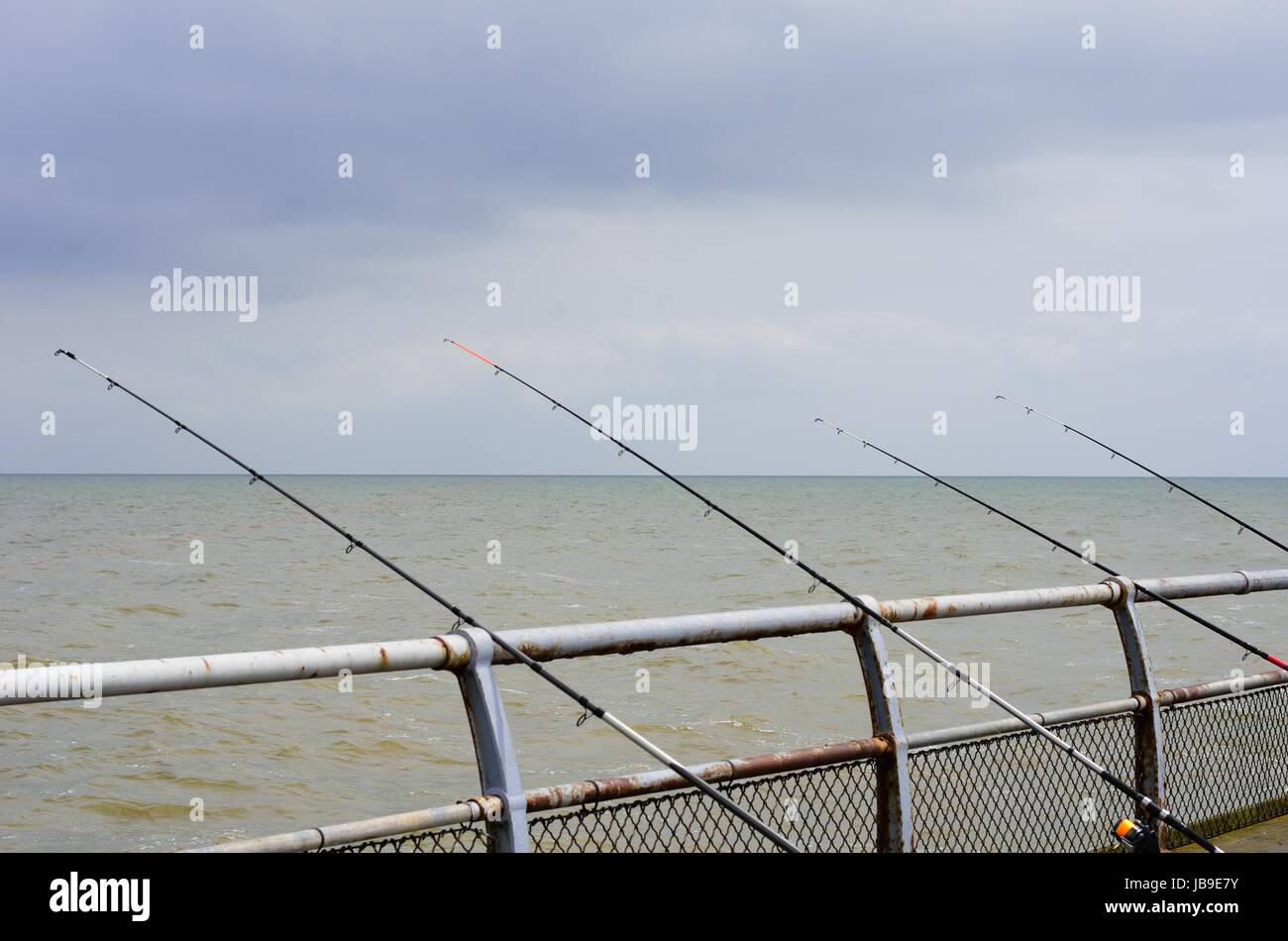 Sea fishing rods on pier Stock Photo - Alamy