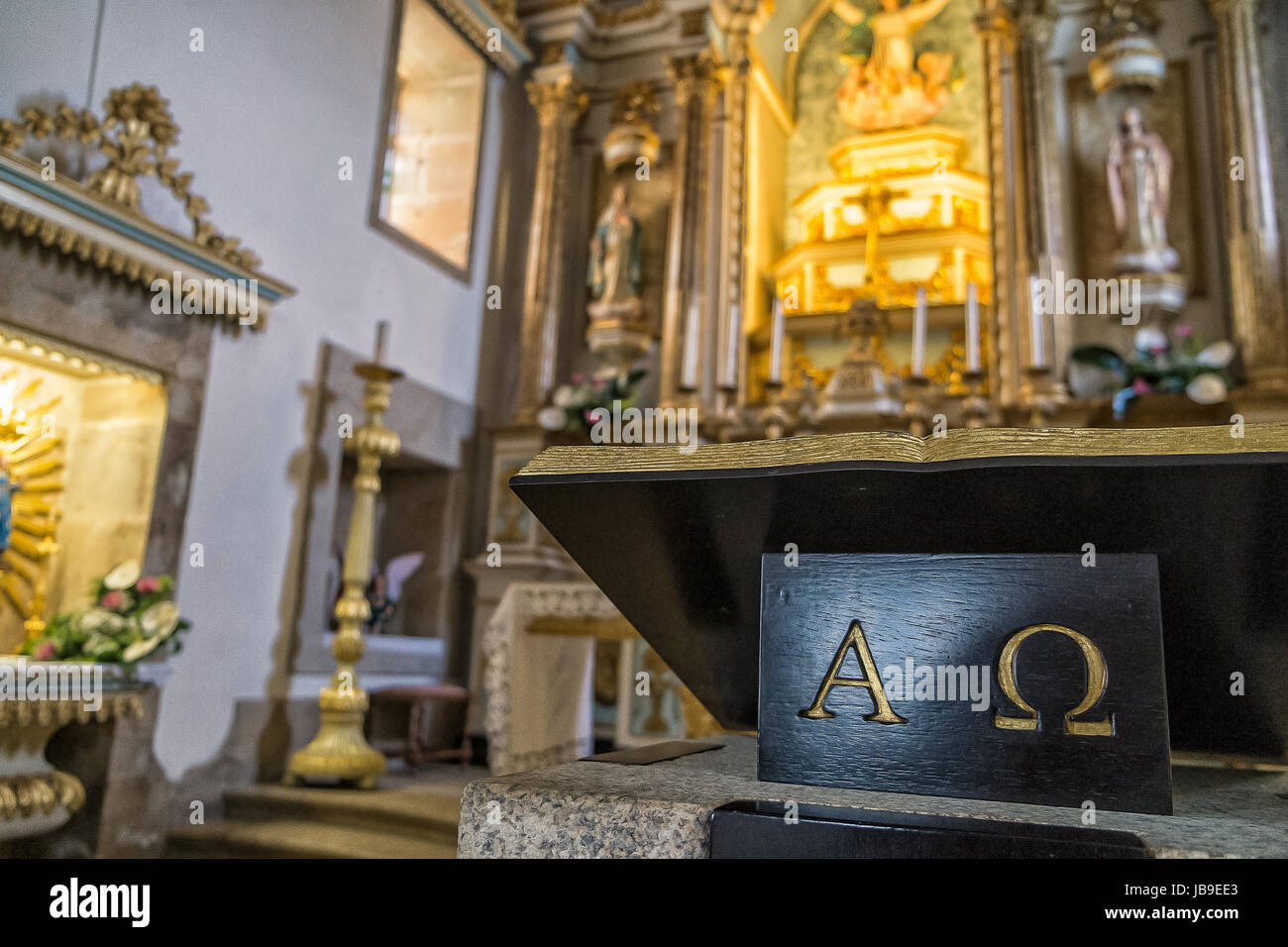 Omega and alpha symbols in a church book Stock Photo - Alamy