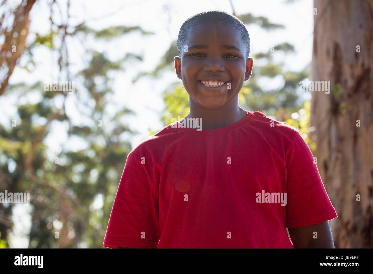 Portrait of boy standing in the boot camp during obstacle course ...