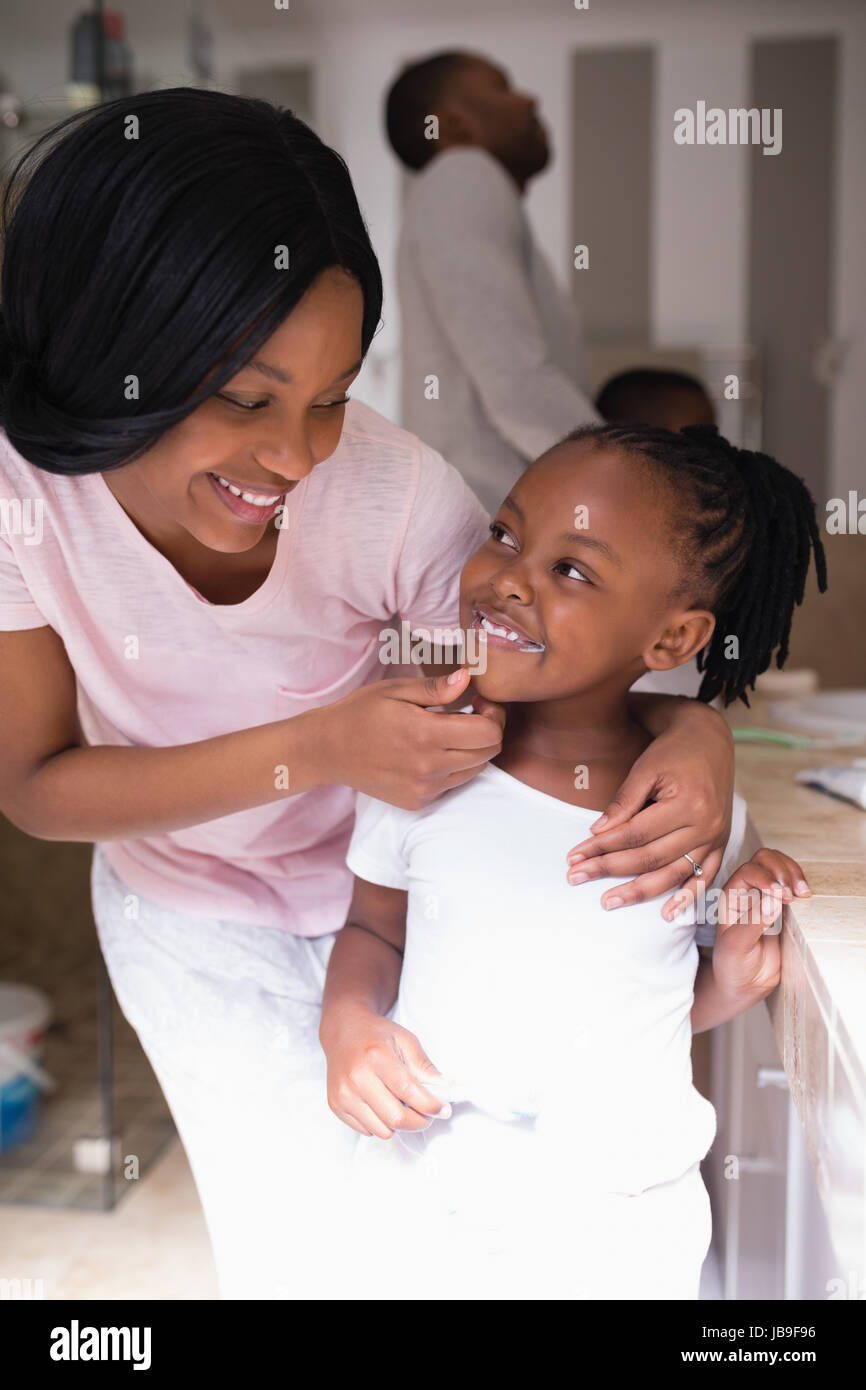 Smiling mother checking daughters teeth in bathroom at home Stock Photo ...