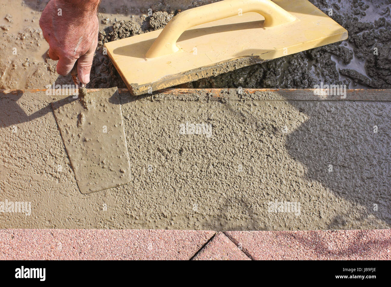 concreting,workers in the smoothing of concrete Stock Photo - Alamy