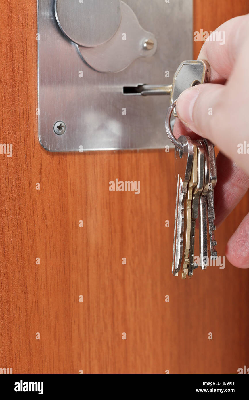 opening home door by bunch of keys close up Stock Photo - Alamy