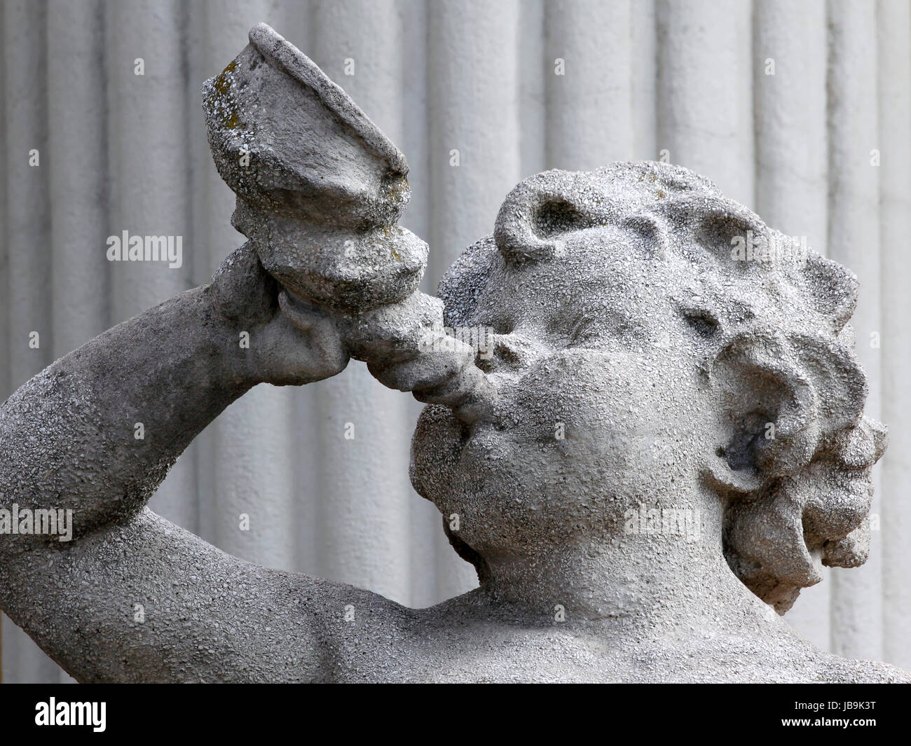 Stone statue of an angel holding a trumpet that blows Stock Photo - Alamy
