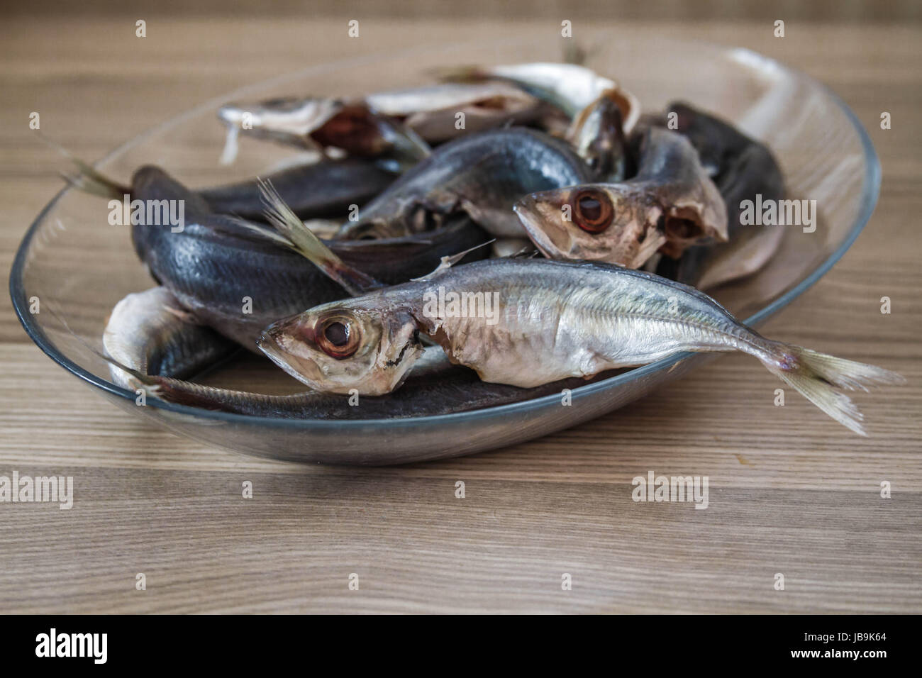 Cleaned mackerel in a glass plate on a wooden background Stock Photo ...