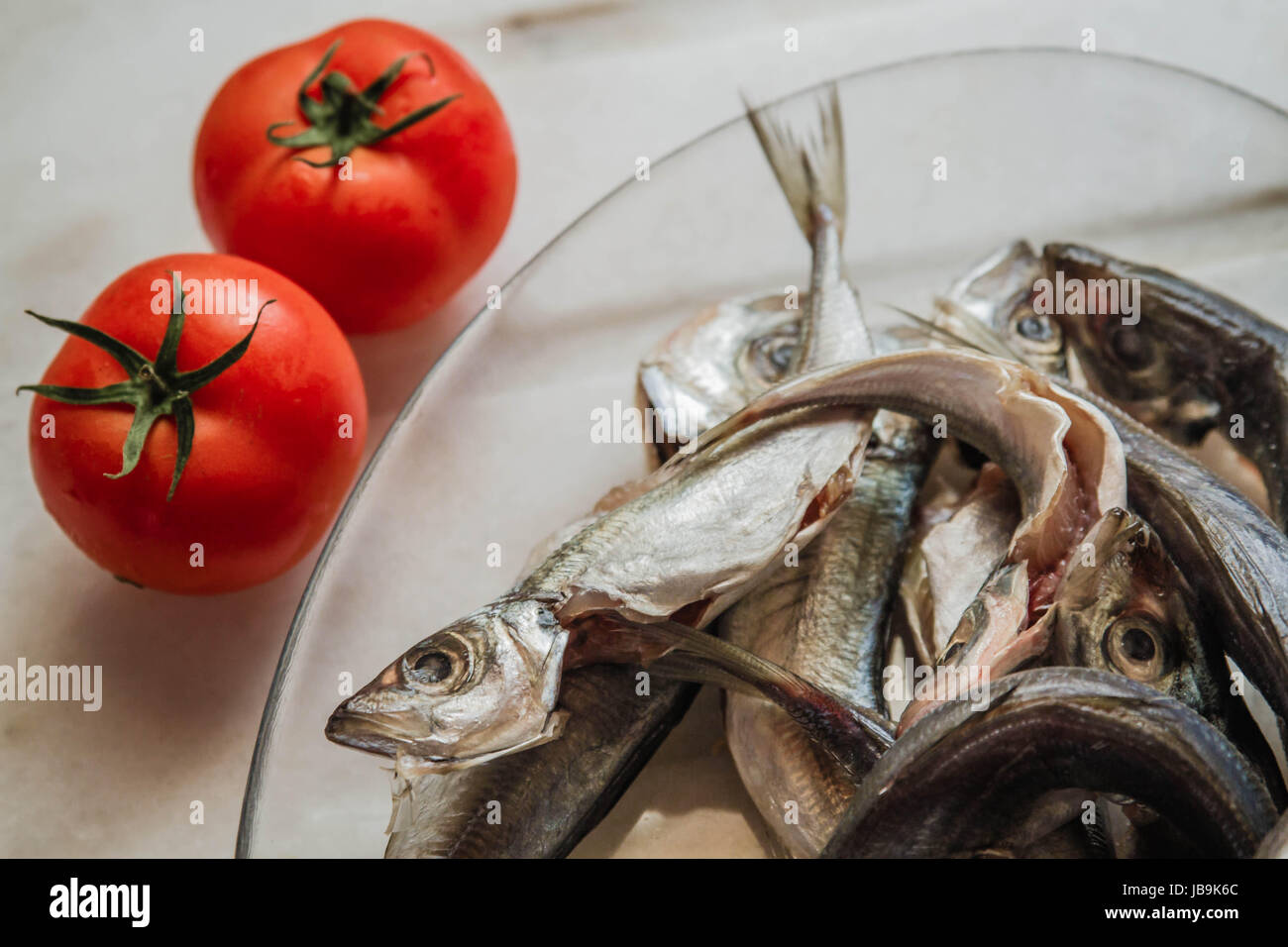 Cleaned mackerel in a glass plate on a white background Stock Photo - Alamy