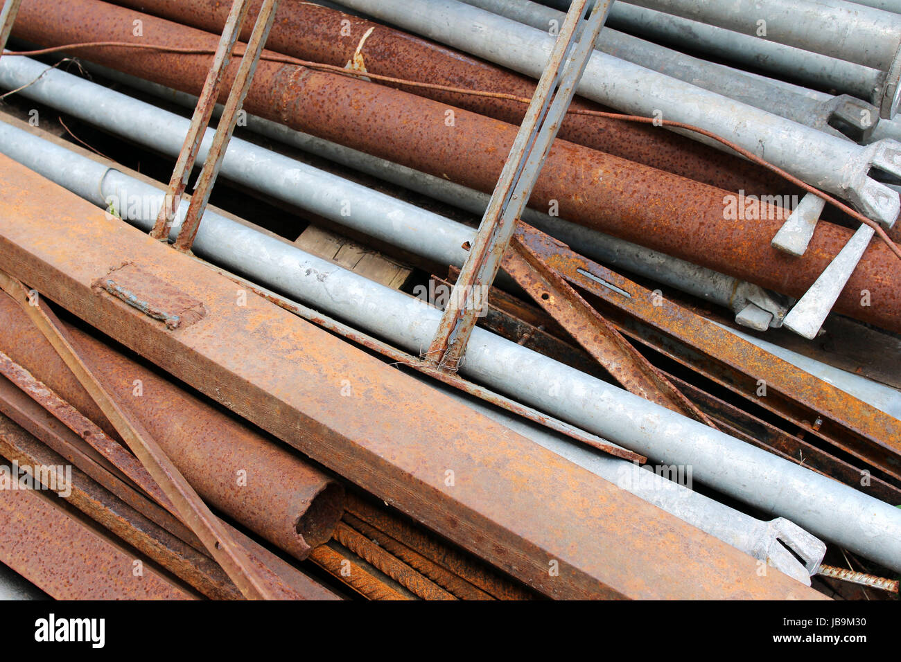 A pile of rusty iron pipes and other metal scrap Stock Photo - Alamy