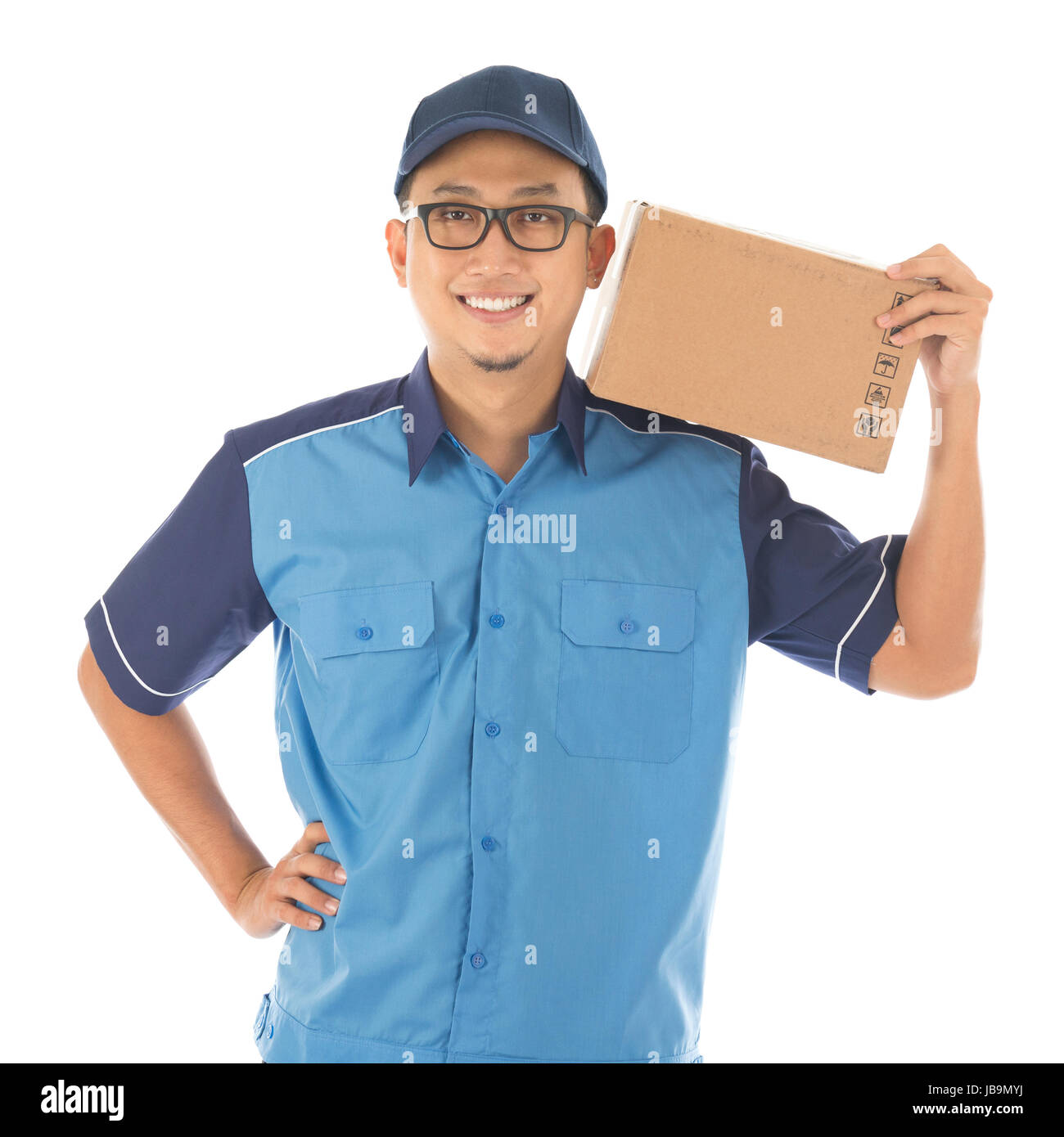 Delivery person delivering package smiling happy in blue uniform ...