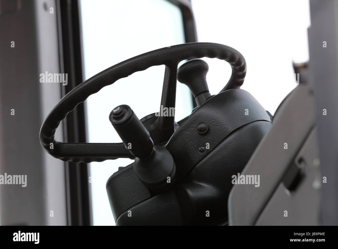 Steering wheel in interior of a new industrial machine Stock Photo - Alamy