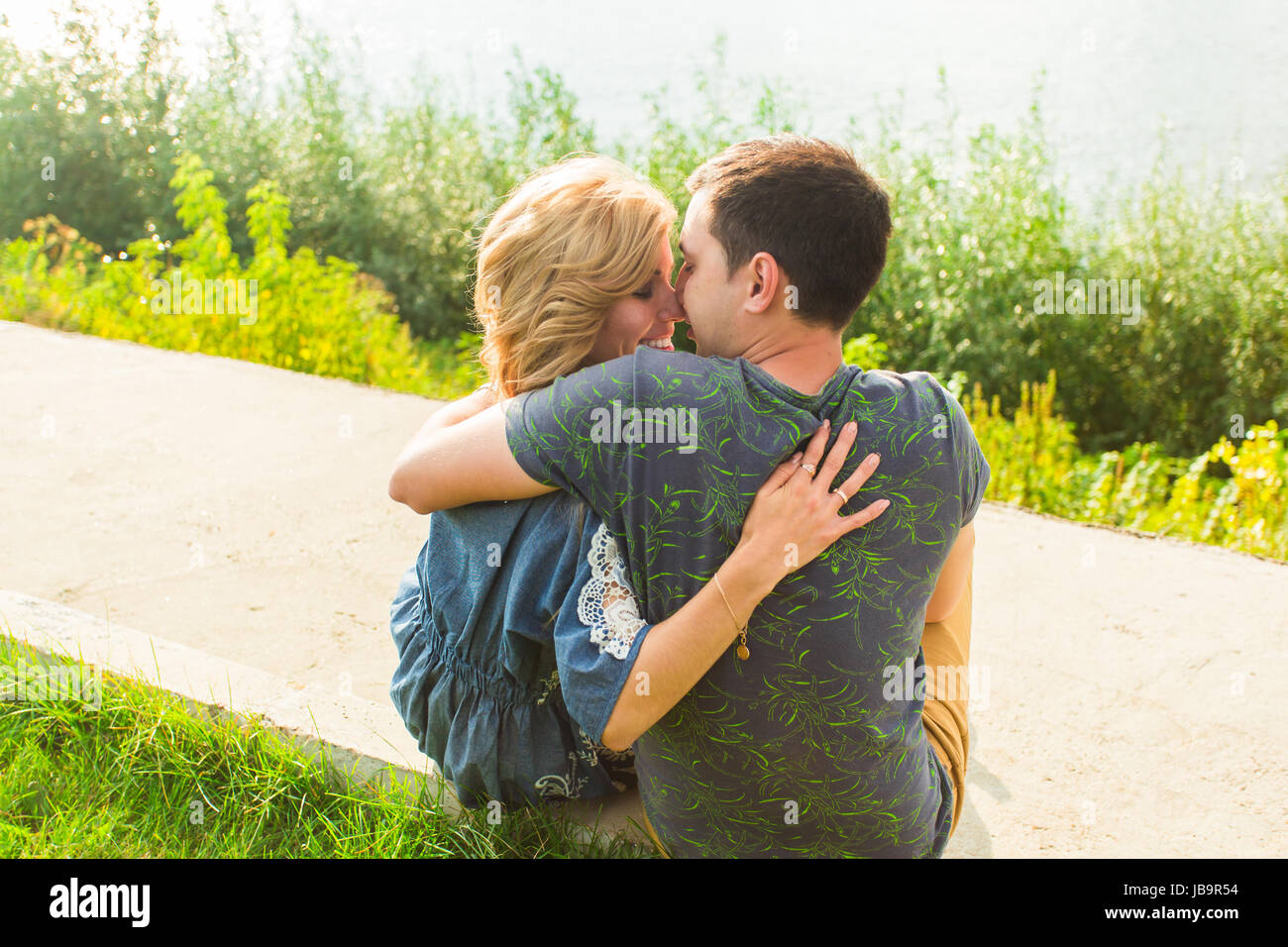 Back view of happy woman hugging her man outside Stock Photo - Alamy