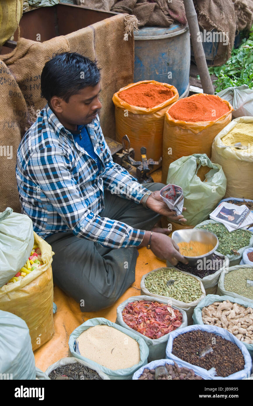Man selling fresh spices from a pavement market stall in Old Delhi ...