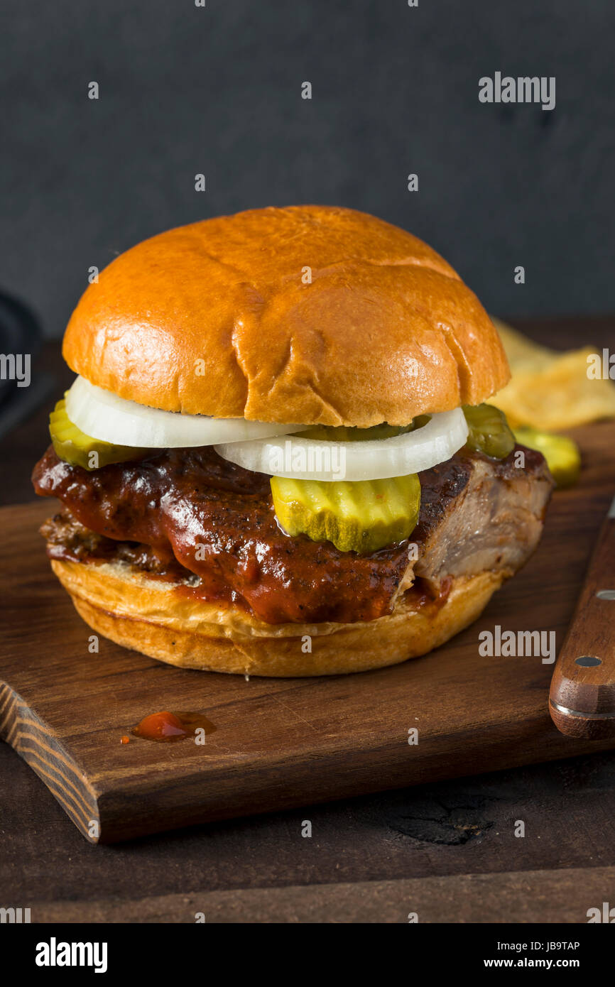 Homemade Smoked BBQ Rib Sandwich with Pickles and Onion Stock Photo - Alamy