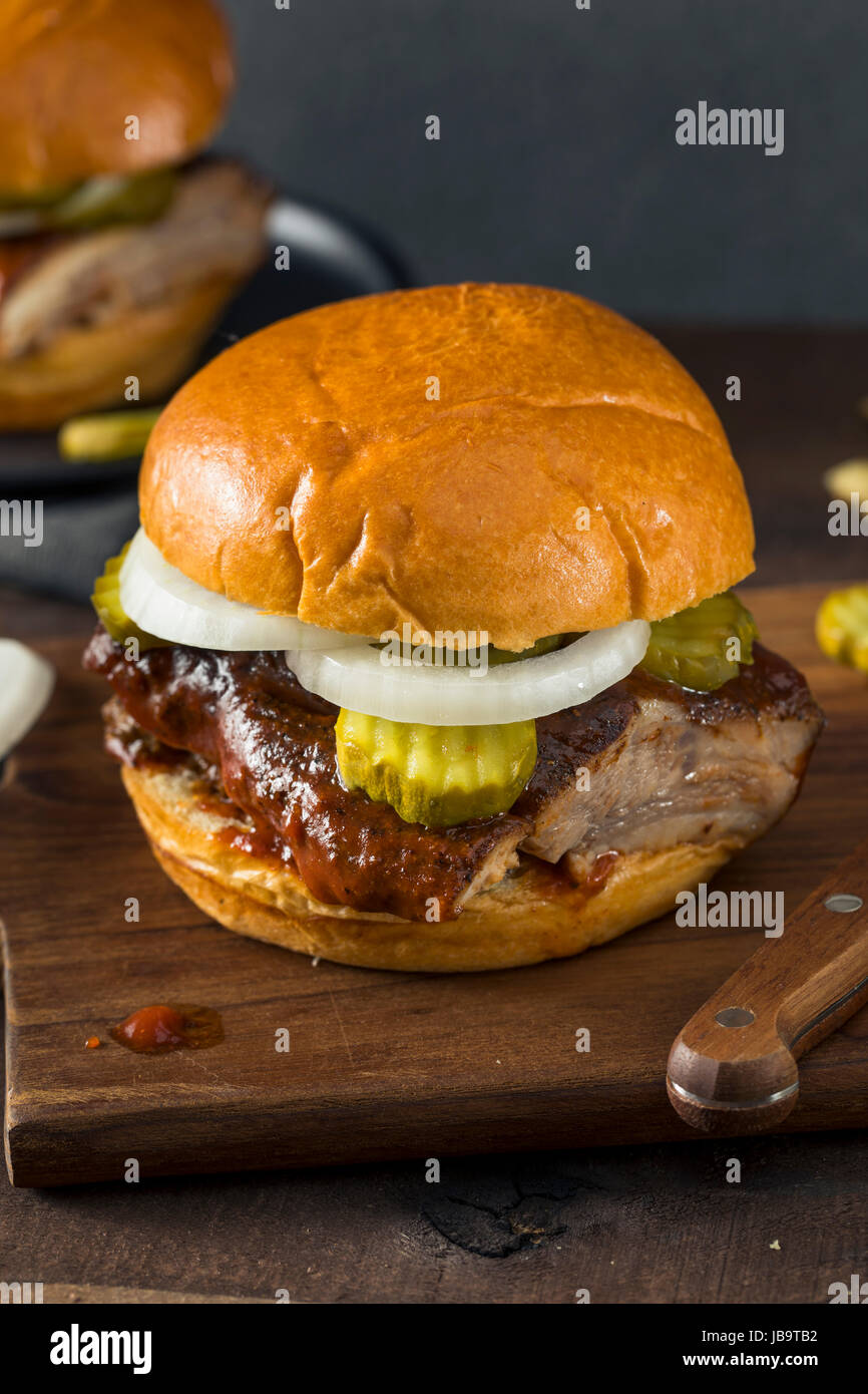 Homemade Smoked BBQ Rib Sandwich with Pickles and Onion Stock Photo - Alamy