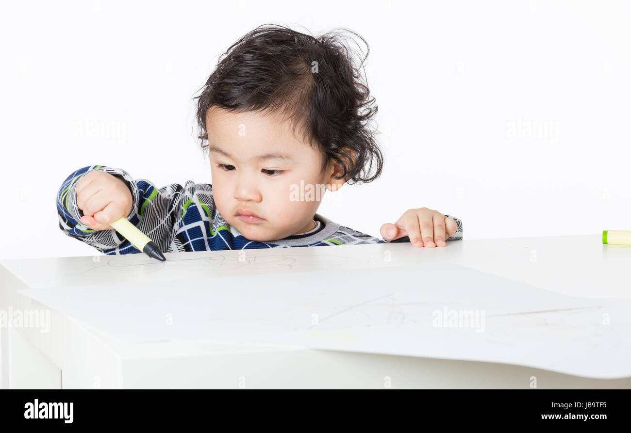 Little boy concentrate on drawing Stock Photo - Alamy