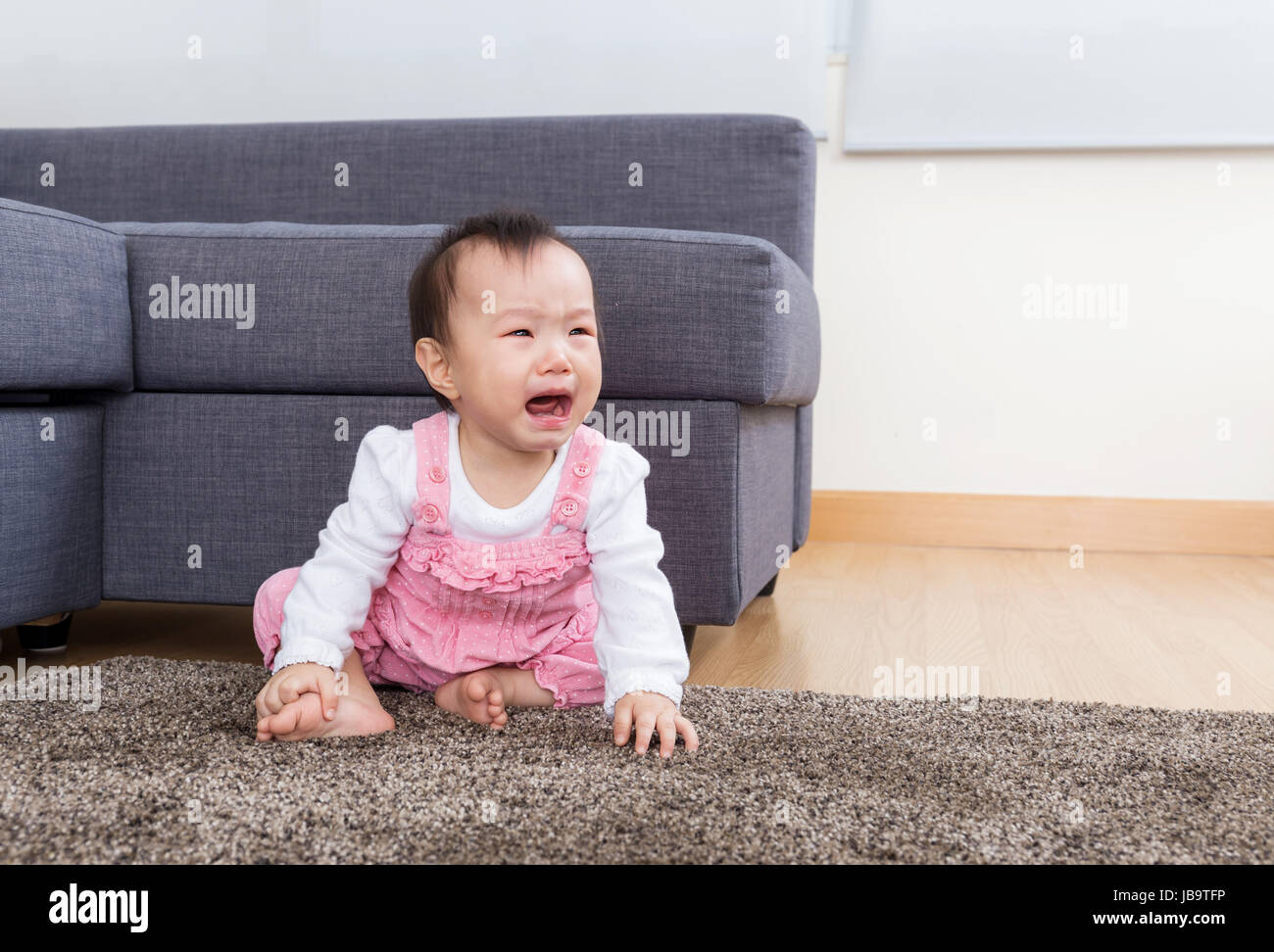 Baby crying at home Stock Photo - Alamy