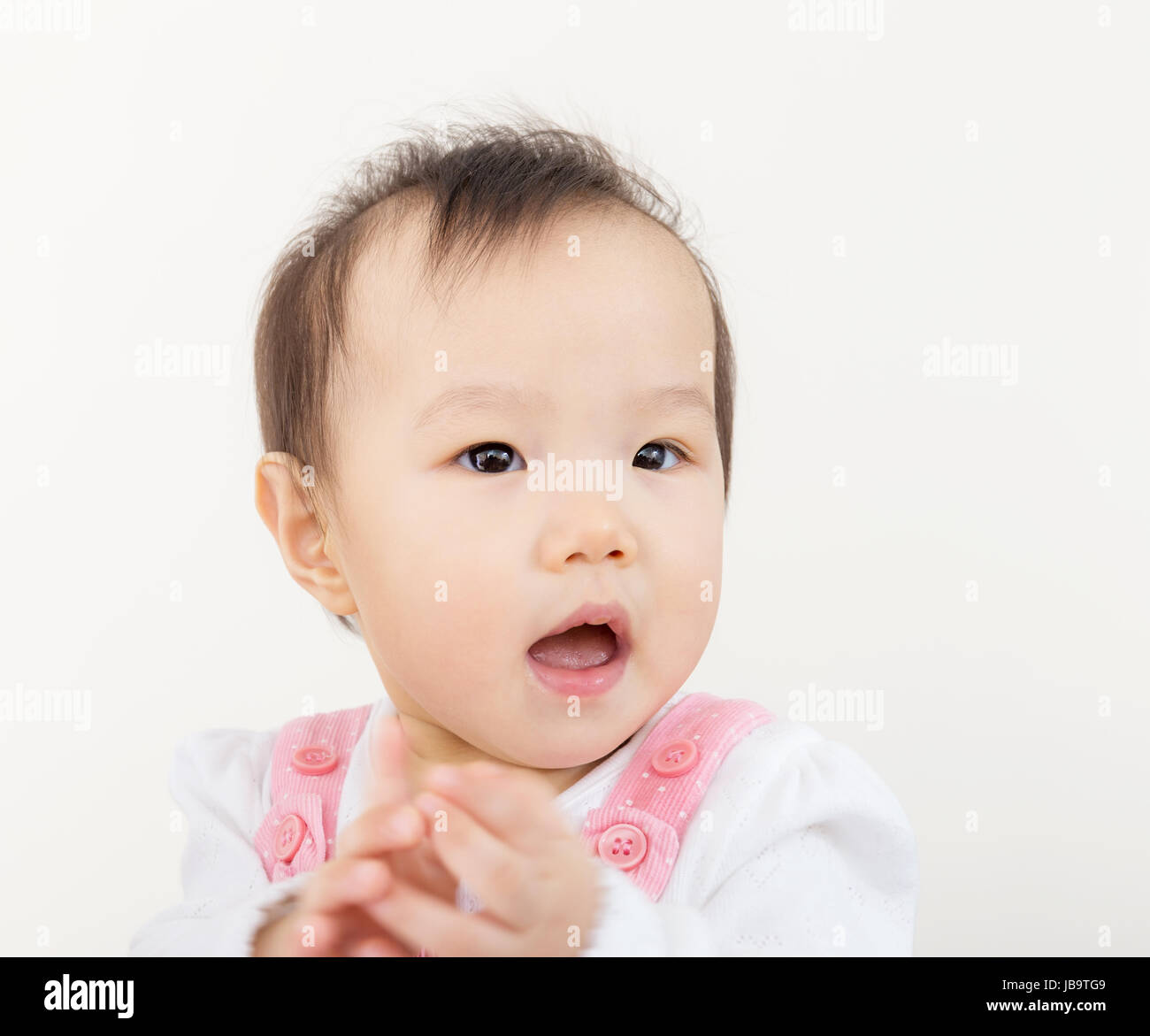 Baby girl clapping hand Stock Photo - Alamy