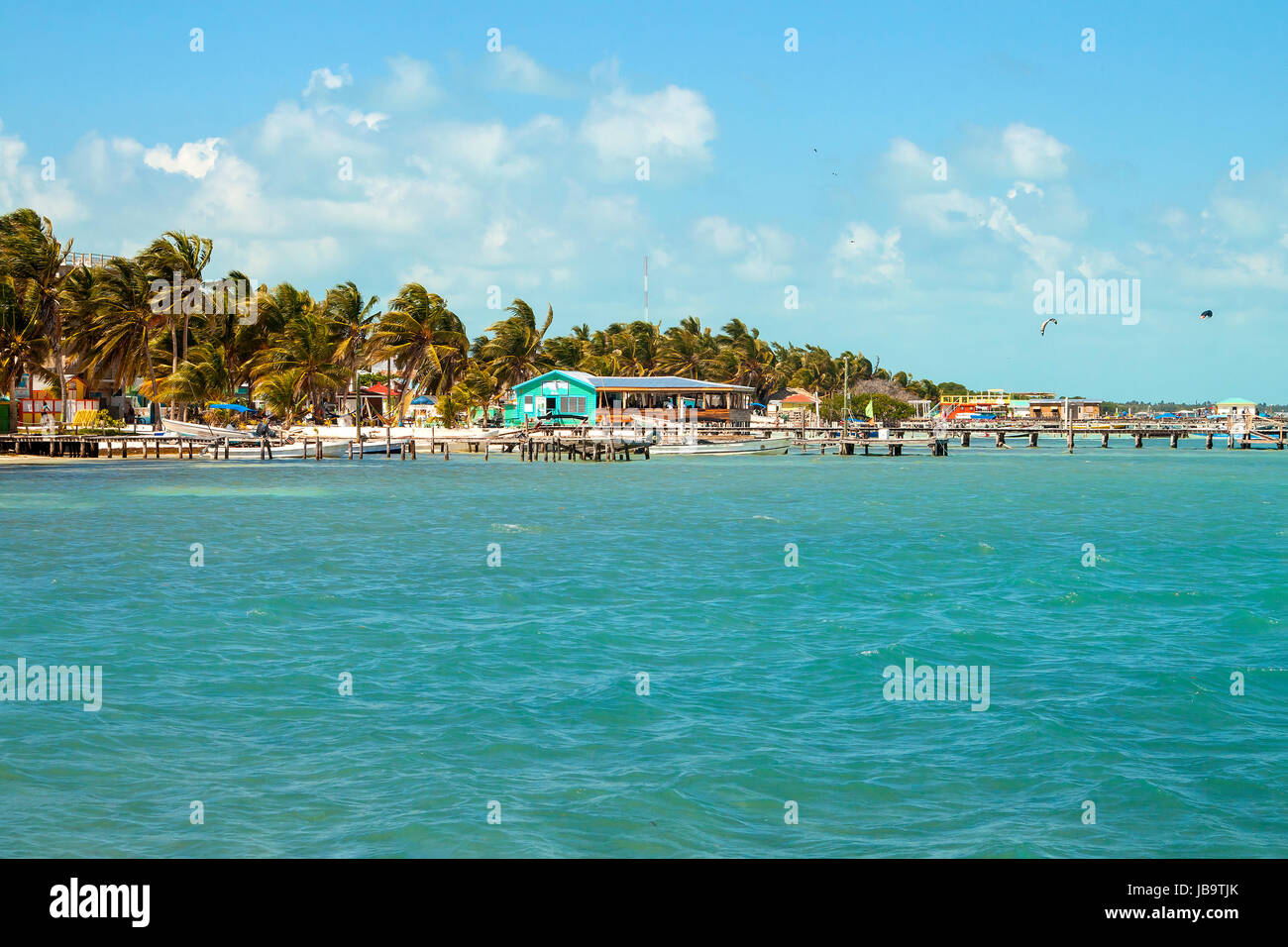 Beautiful tropical shoreline with piers for boats on the island of Caye ...