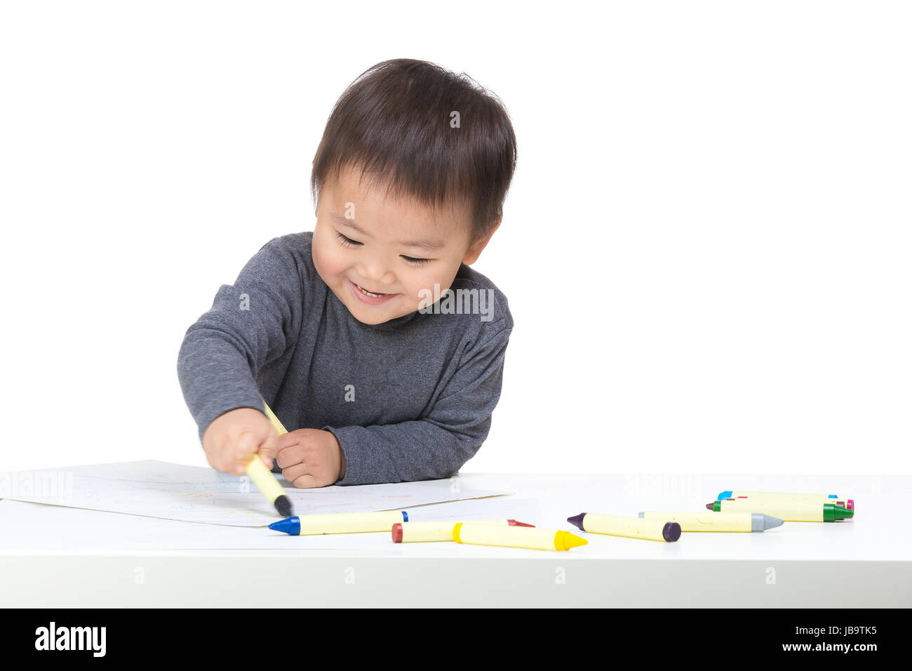 Asian boy drawing with crayon Stock Photo - Alamy