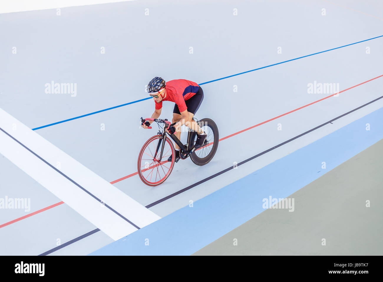 Cyclist finishes on velodrome Stock Photo - Alamy