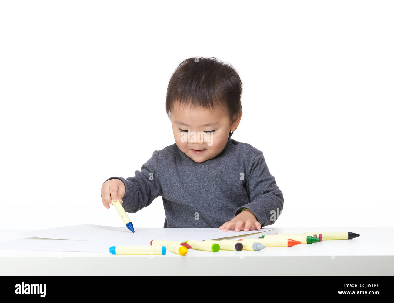 Asian baby boy concentrate on drawing Stock Photo - Alamy