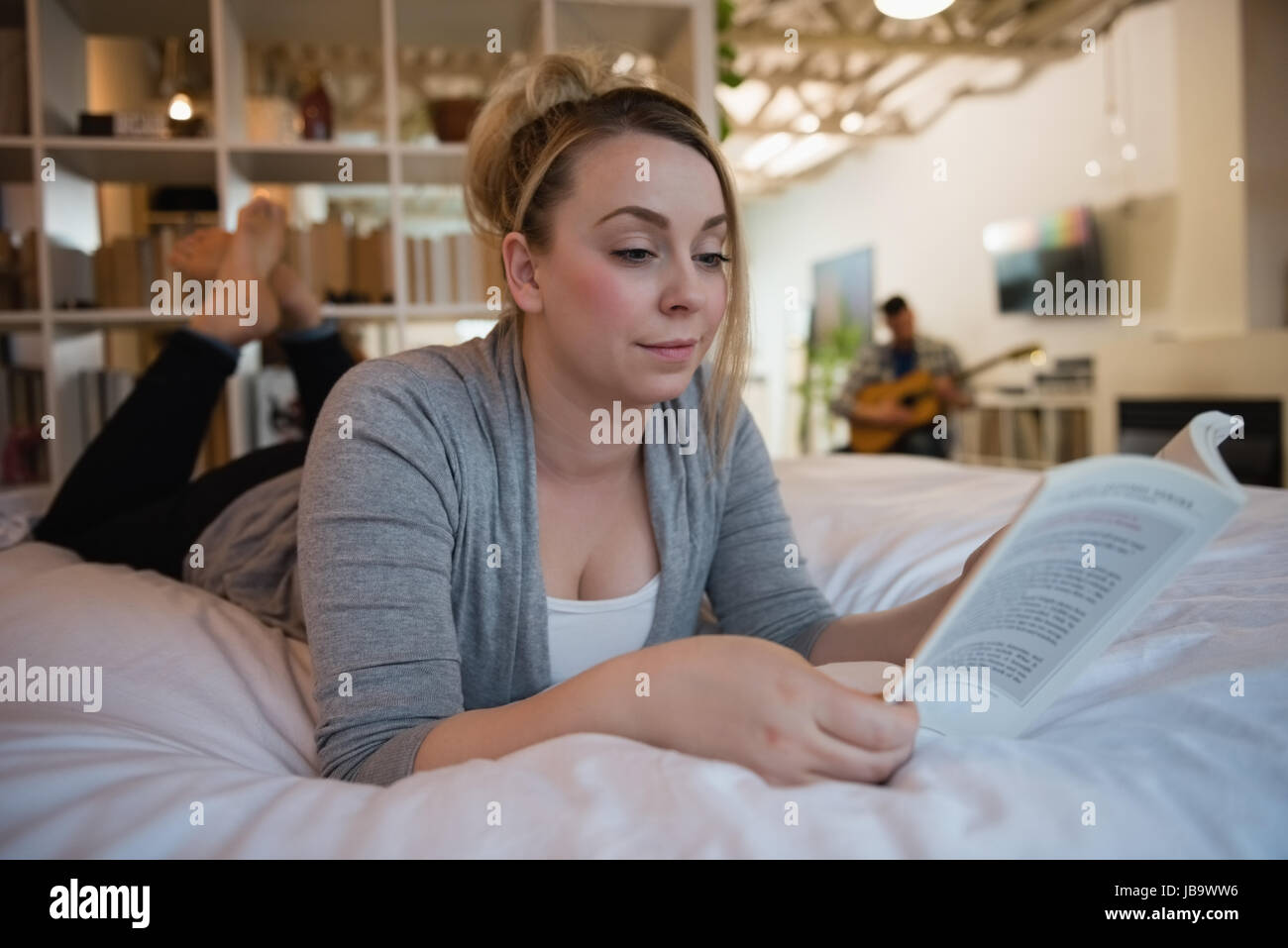 Woman reading smiling home hi-res stock photography and images - Alamy