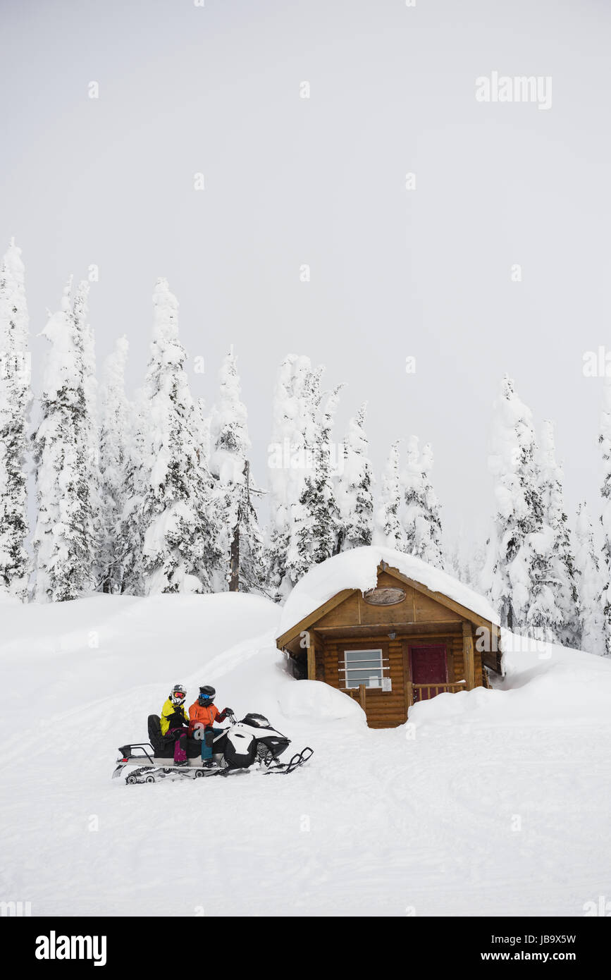 Couple riding snowmobile in snowy alps during winter Stock Photo - Alamy