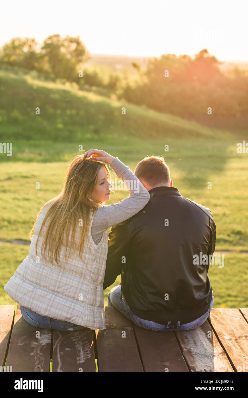 couple hugging on a pier in nature back view Stock Photo - Alamy