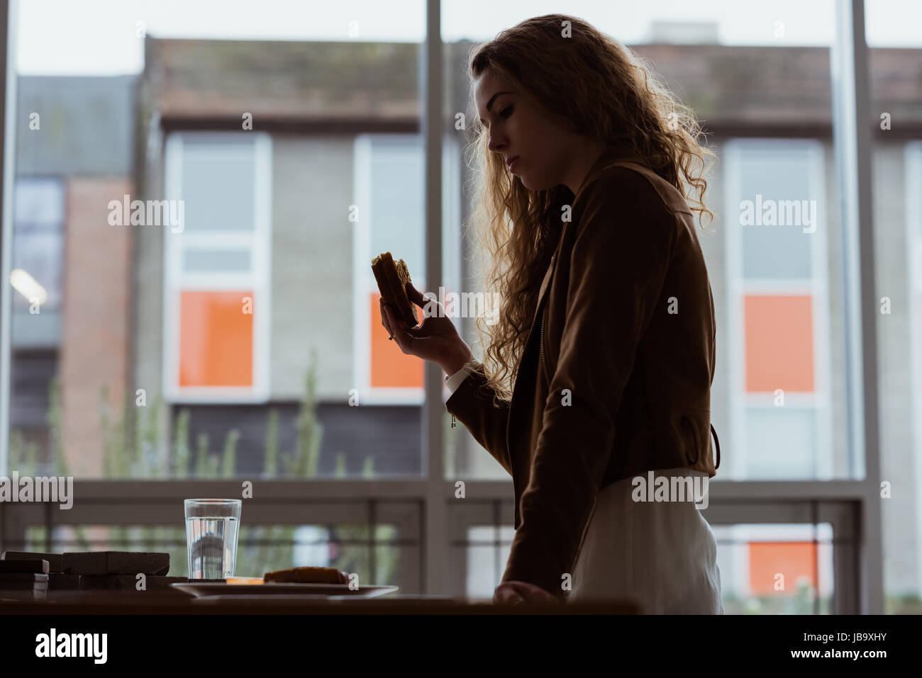 Female executive having breakfast in office Stock Photo - Alamy