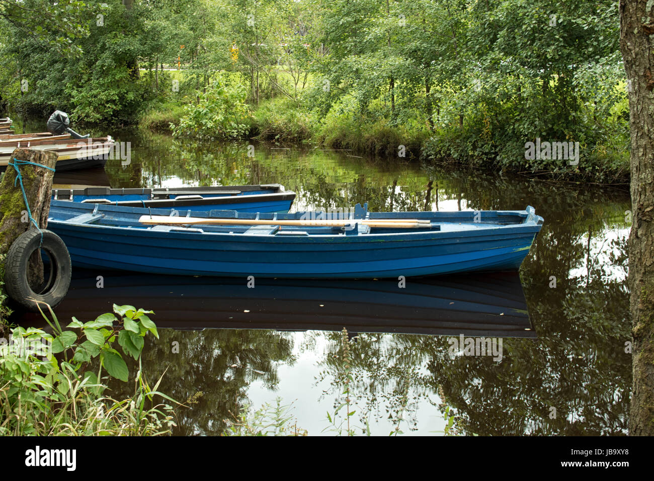 Blue rowboat on lake Stock Photo - Alamy