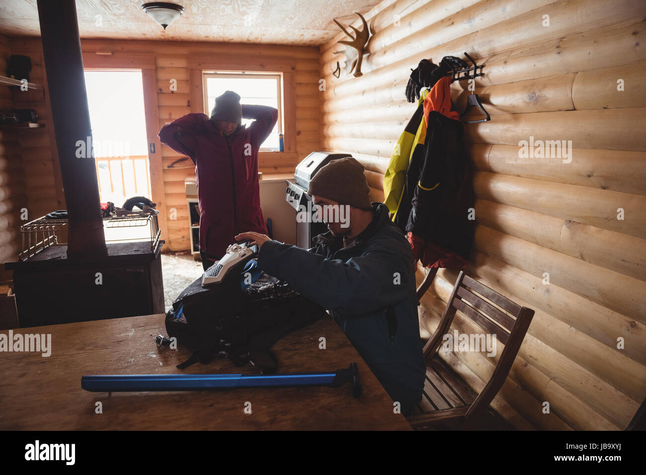Woman sitting in log cabin hi-res stock photography and images - Alamy