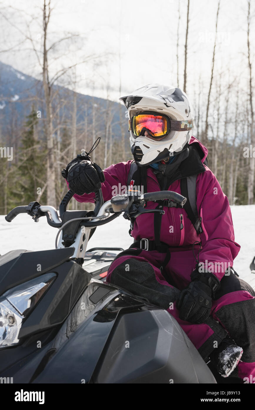 Woman sitting on snowmobile hi-res stock photography and images - Alamy