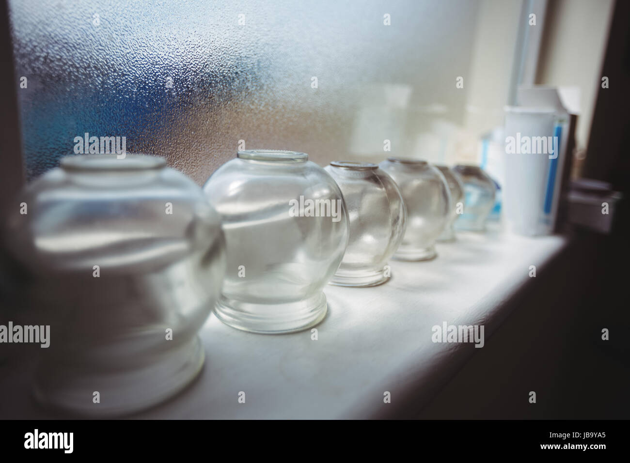 Cupping glasses arranged on windowsill in spa Stock Photo - Alamy