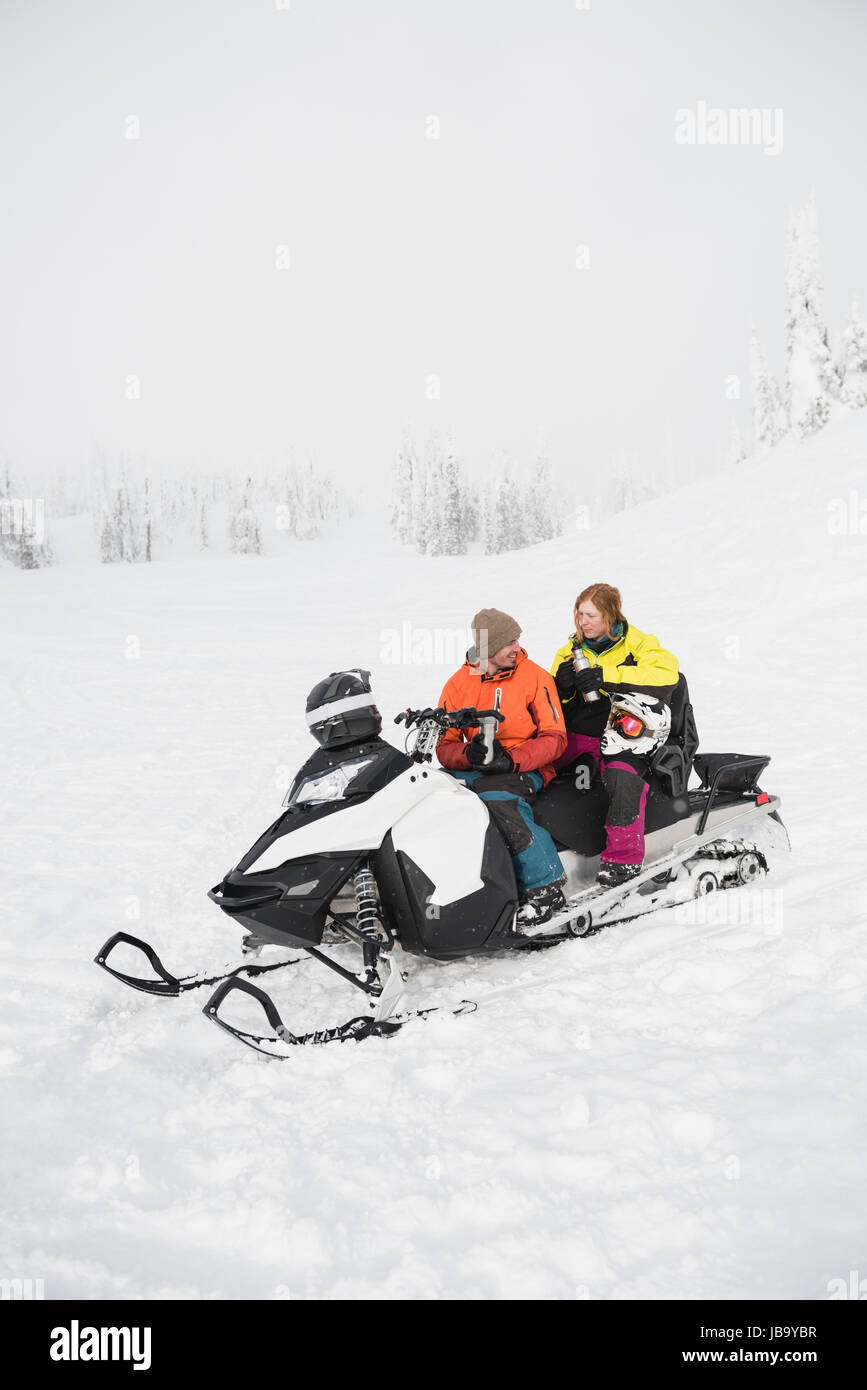 Woman sitting on snowmobile hi-res stock photography and images - Alamy