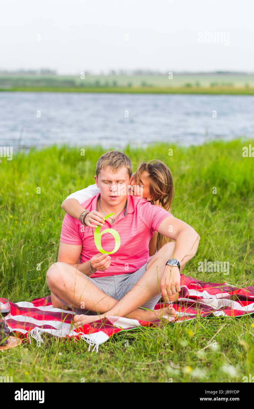 Man and woman holding the number 6 in nature. Concept of numbers ...
