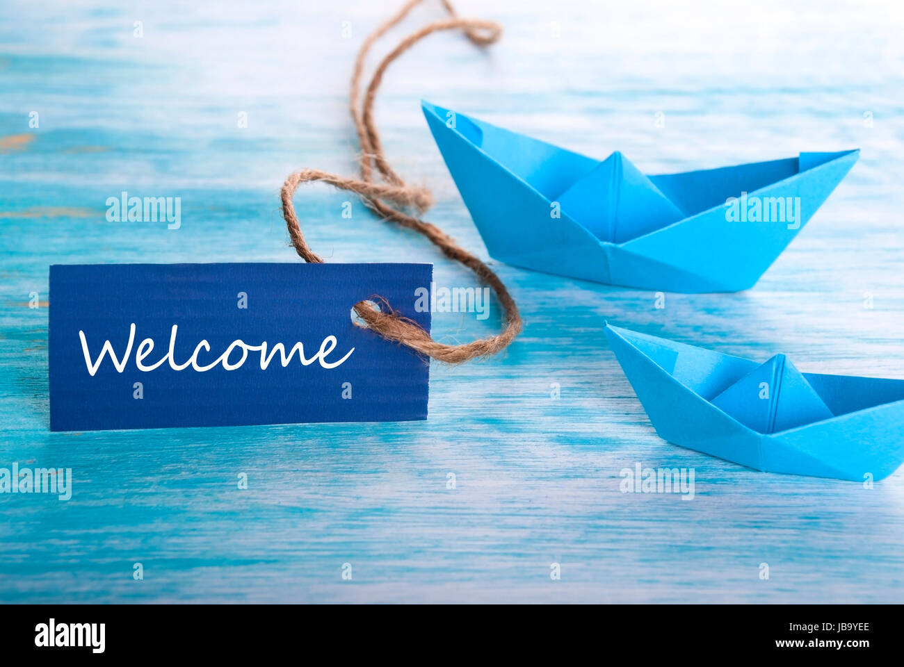 Welcome Tag with Boats, blue Nautical Background Stock Photo - Alamy