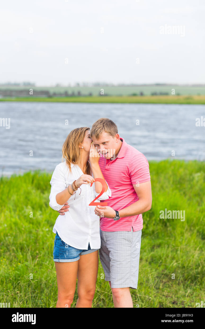 Man and woman holding the number 2 in nature. Concept of numbers ...