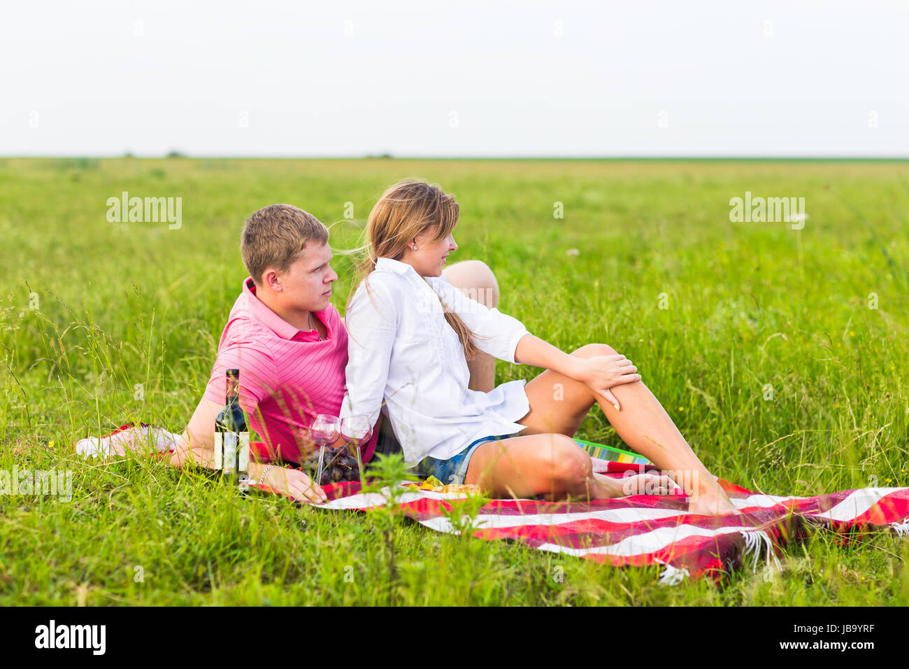 Beautiful love couple having romantic picnic outdoors on summer sunny ...