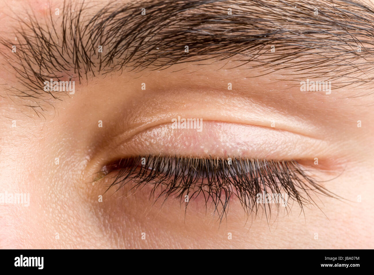 shoot of beautiful teenager man closed eye macro Stock Photo - Alamy