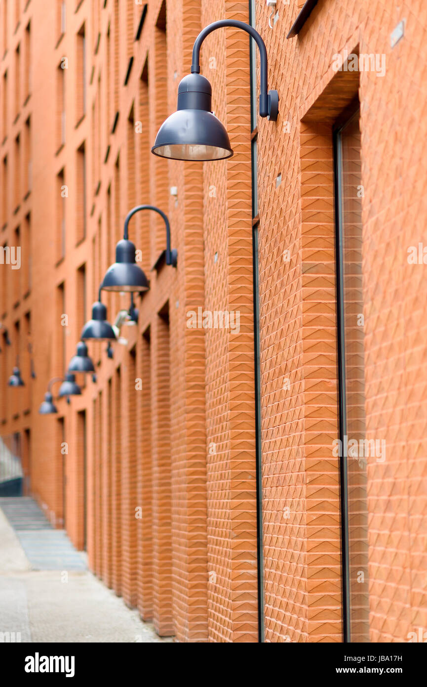 Frontage of modern red brick building ith visible fragments of windows ...