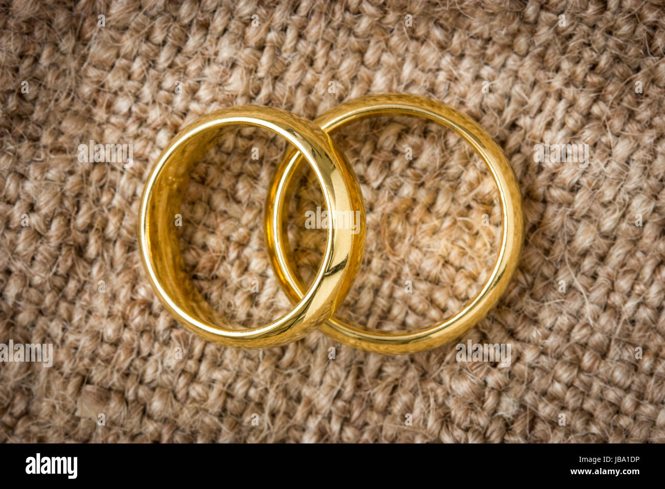 Two golden rings on the burlap background Stock Photo - Alamy