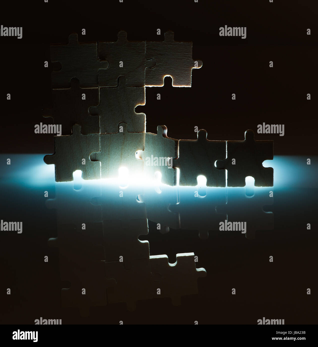 Wooden puzzle and backlight background. Vertically stacked parts Stock ...