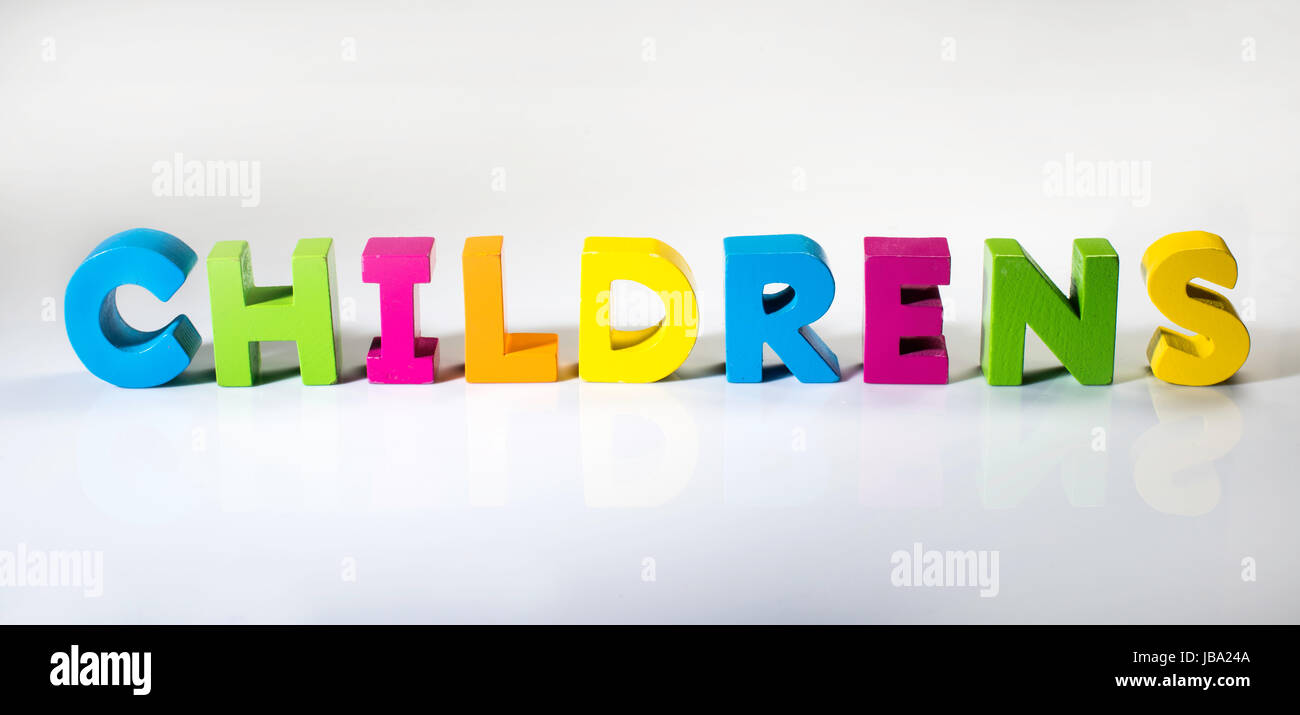 Multicolored text childrens made of wood. White background Stock Photo ...