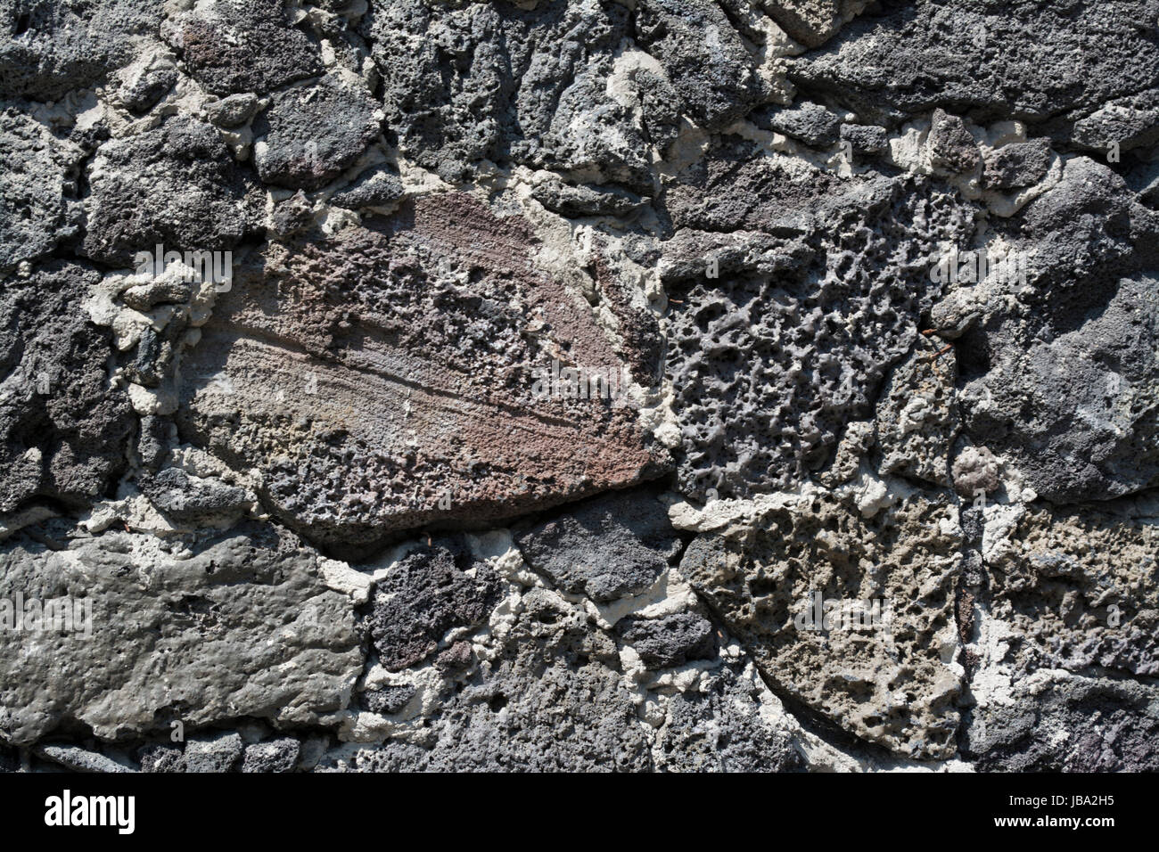 Wall of volcanic rock and cement to detail Stock Photo - Alamy