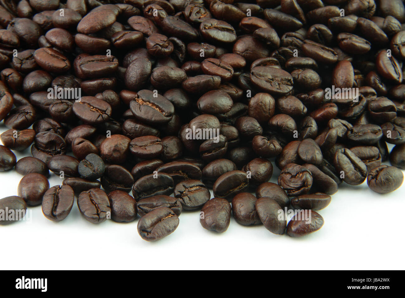 many coffee beans on the white background Stock Photo - Alamy
