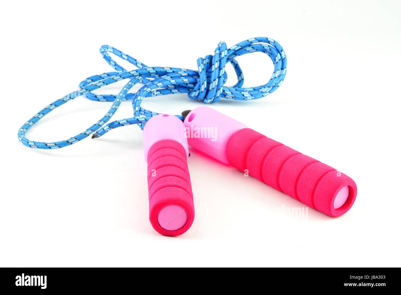 a red skipping rope isolated in white background Stock Photo - Alamy