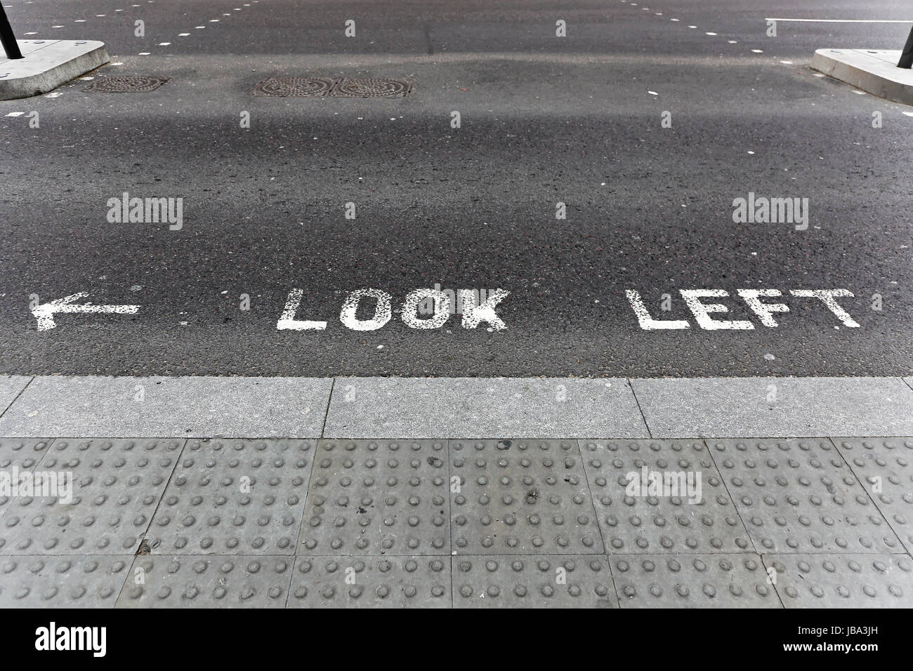 Look left safety sign at street crossing in London Stock Photo - Alamy