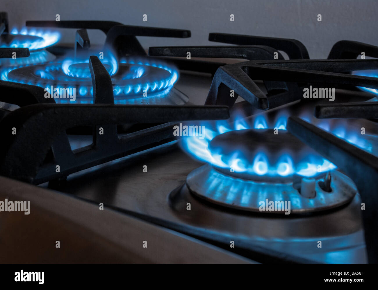cookers home kitchen with the typical blue flame Stock Photo - Alamy